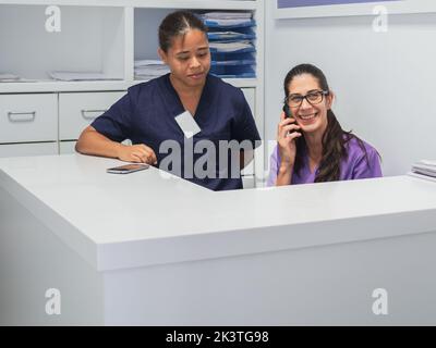 Nurse working behind nurses counter Stock Photo - Alamy