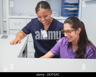 Nurse working behind nurses counter Stock Photo - Alamy