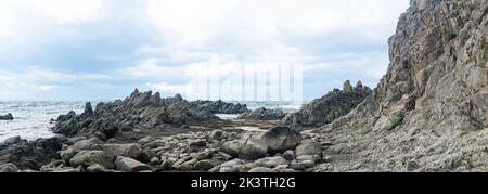 sharp jagged basalt rocks on the sea coast Stock Photo - Alamy