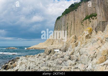 high coastal cliff formed by stone columns, Cape Stolbchaty on the ...
