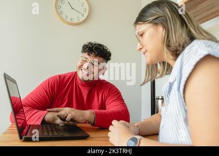 Positive Hispanic female in eyeglasses and casual clothes sitting at ...