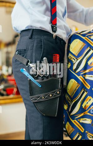 Barber tools in a leg pouch: scissors, razors, combs Stock Photo - Alamy