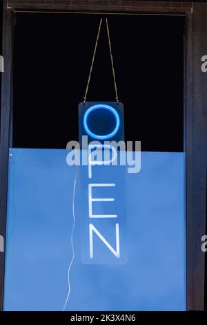 Bright neon open sign hanging in a shop window Stock Photo - Alamy