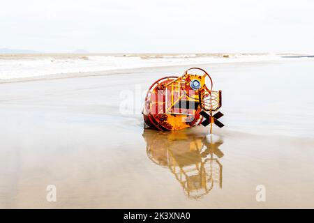 A large buoy buried in the sand at the beach after typhoon Noru went ...