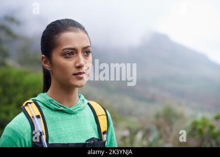 She loves trail running. A beautiful young woman standing against a ...