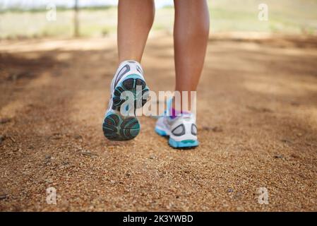 Going for a trail run. Cropped view of a womans legs running through a ...
