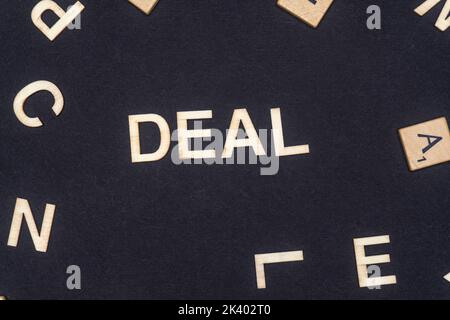 DEAL word written on dark paper background. DEAL text on dark for your ...