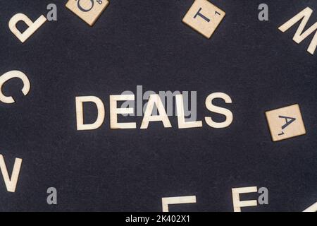 DEALS word written on dark paper background. DEALS text on dark for ...