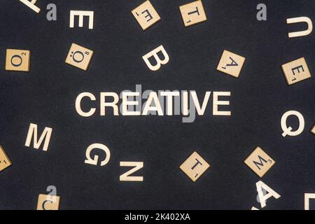 CREATIVE word written on dark paper background. CREATIVE text on dark ...