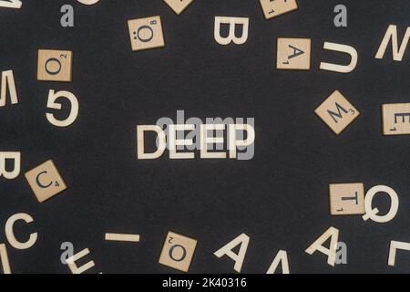 DEEP word written on dark paper background. DEEP text on dark for your ...