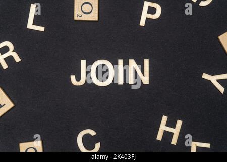 JOIN word written on dark paper background. JOIN text on dark for your ...