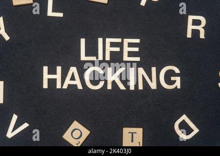 LIFE HACKING word written on dark paper background. LIFE HACKING text ...