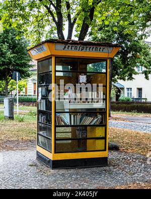Old yellow telephone box now a tiny lending library, Lübars ...