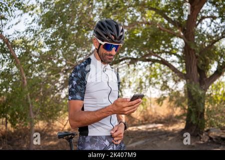 The Cyclist Checks The Results On His smartphone After Riding . Sport ...