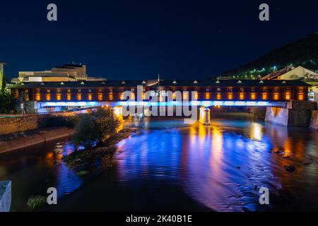 The colorful covered bridge in Lovech, Bulgaria at night. The bridge is ...