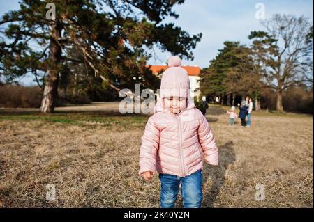 Baby girl, wear pink jacket walking at Valtice park, Czech Republic ...