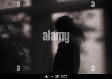 Silhouette of lonely woman at home. Unknown female person shadow on ...