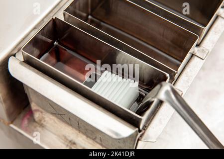 Slides with paraffin embedded tissue samples into a slide staining rack ...