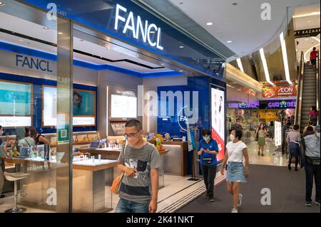 Shoppers walk past the Japanese cosmetics and dietary supplements ...