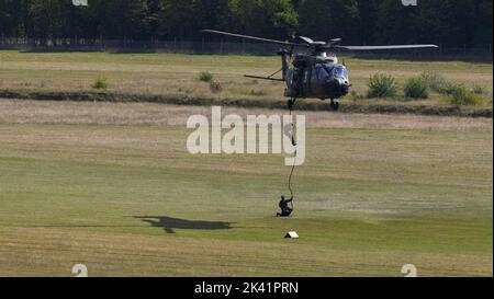 German army soldiers fast-roping from a NH90 helicopter and a Sikorsky ...
