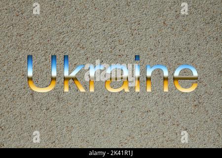 Inscription «Ukraine». Text in Ukrainian style, is lying on a grey ...