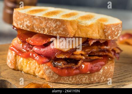 Homemade British Bacon Sandwich on a rustic wooden board, side view ...