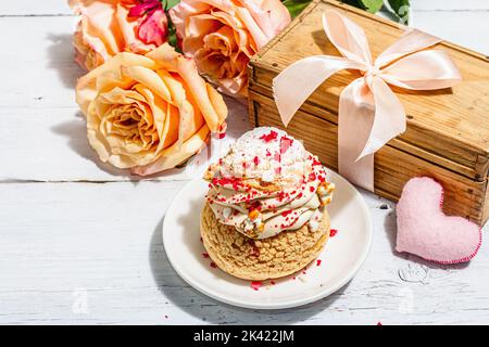 The concept of romantic gift. French Shu cake, hibiscus tea, bouquet of ...