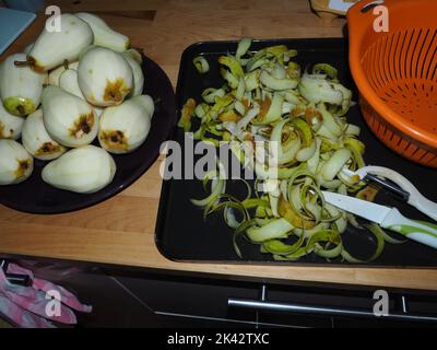 Pear preservation in process. Ripe fruit peeled on a metal tray and ...