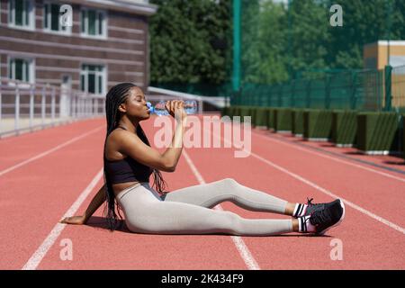 woman drinks water after running Stock Photo - Alamy