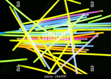 Image of vibrant stack of neon glow sticks scattered over black ...