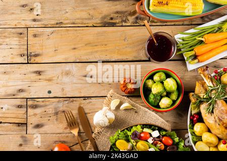 Overhead view of thanksgiving table with roast chicken and vegetables ...
