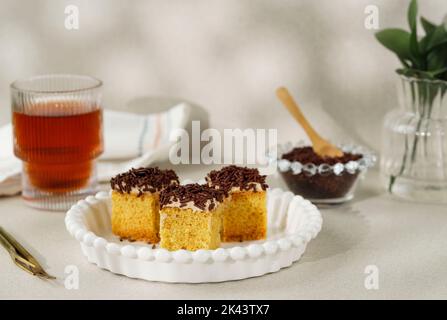 Sliced Mocca Cake with Chocolate Sprinkle Topping, Served with Tea ...
