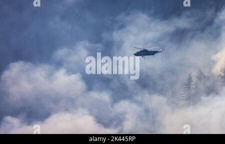 Wildfire Service Helicopter flying over BC Forest Fire and Smoke on the ...