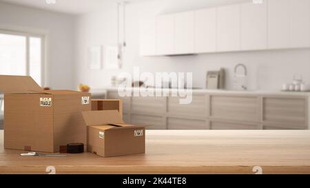 Wooden table, desk or shelf with stack of cardboard boxes over blurred ...