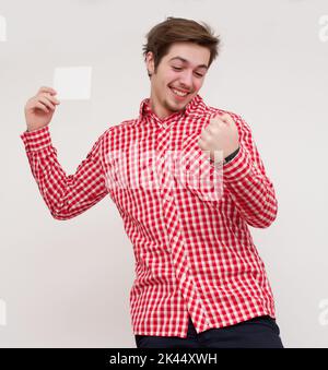 handsome man Red paper billboard advertising christmas light background ...