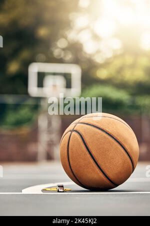 Basketball on floor of empty basketball court vintage with dramatic ...