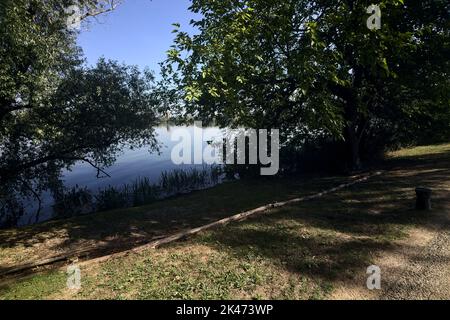 Gravel path in a park by the lakeshore at sunset Stock Photo - Alamy