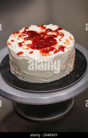 Bleeding monster cake with knife on cake stand Stock Photo - Alamy
