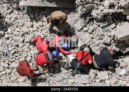 Iraqi emergency and rescue personnel search for survivors in the rubble ...