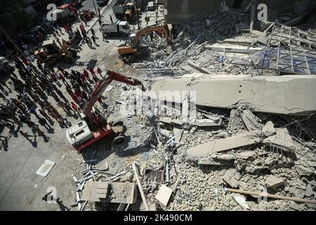 Iraqi emergency and rescue personnel search for survivors in the rubble ...