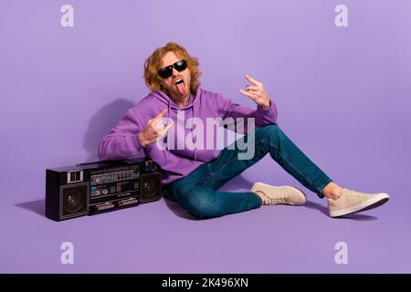 Photo of hooray beard guy listen music dance wear headphones orange t ...