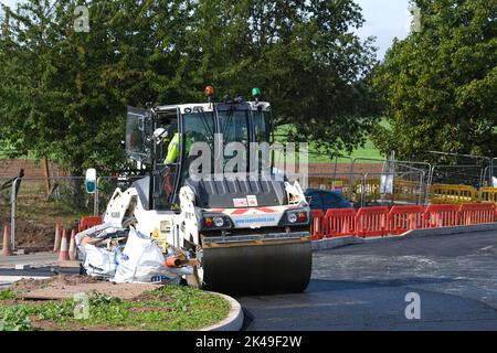 road roller rolling tarmac on a new road Stock Photo - Alamy