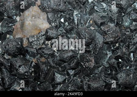 Cassiterite, tin oxide mineral, tin ore isolated on black background ...