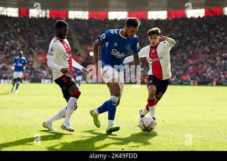 Everton's Dwight McNeil (centre) battles for the ball with Chelsea's ...