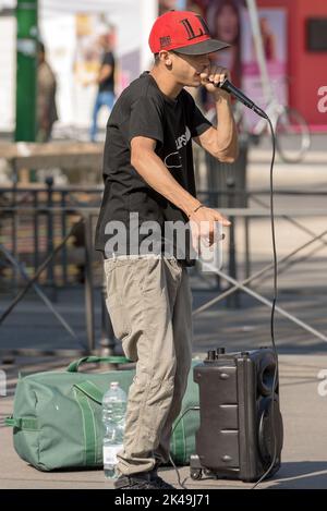 A boy beatbox performs in a street of the city center of Milan. The ...
