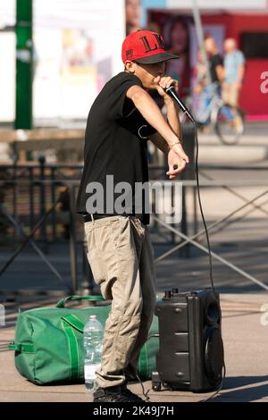 A boy beatbox performs in a street of the city center of Milan. The ...