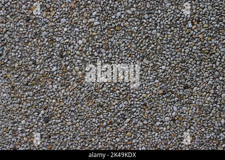 Small pebbles in concrete wall for background Stock Photo - Alamy