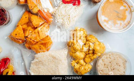 A top view of snacks and servings of food in plastic containers Stock ...