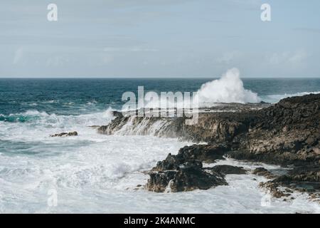 Water splash on black volcanic rocks of Tenesar, Lanzarote, Canary ...
