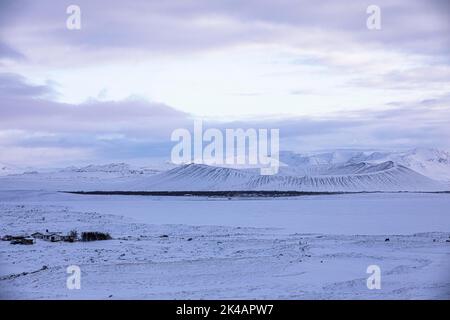 Snow-covered extinct volcano Hverfjall at blue hour, near Lake Myvatn ...